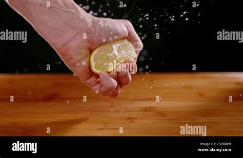 Person Hand Squeezing Fresh Lemon With Squirting Juices Super Slow