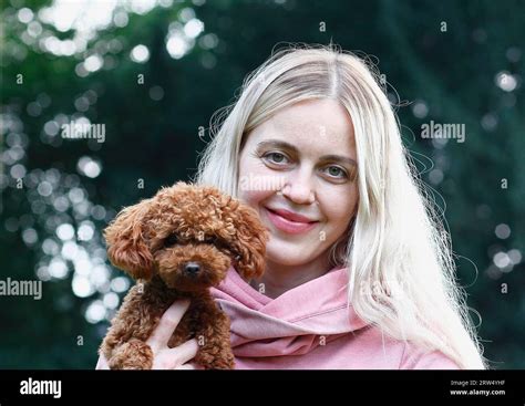 Young Woman With Toy Poodle Canis Lupus Familaris 9 Months Apricot North Rhine Westphalia