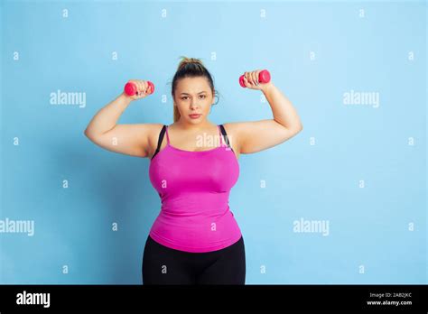 Young Caucasian Plus Size Female Models Training On Blue Background