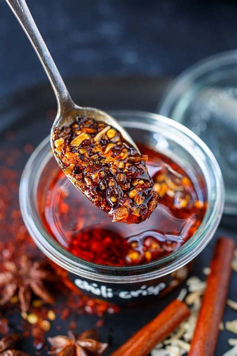 A Spoon Full Of Chili Sauce With Spices Around It
