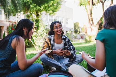 Premium Photo Smiling Students Sitting On The Grass