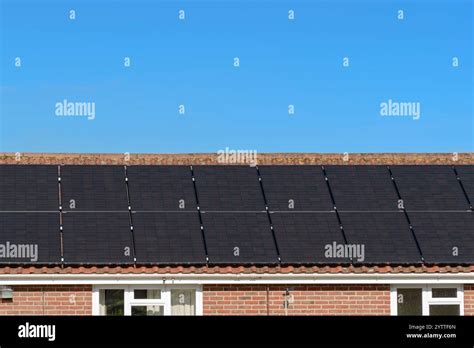 Solar Panel Array Installed On The Roof Of A Domestic Home With A Clear