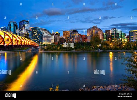 Peace Bridge Across The Bow River And Calgary Skyline Photographed At