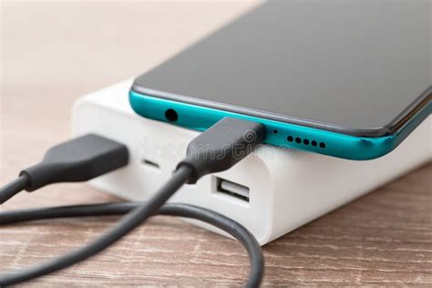 Close Up Shot Of Mobile Phone Charging From Power Bank Stock Image