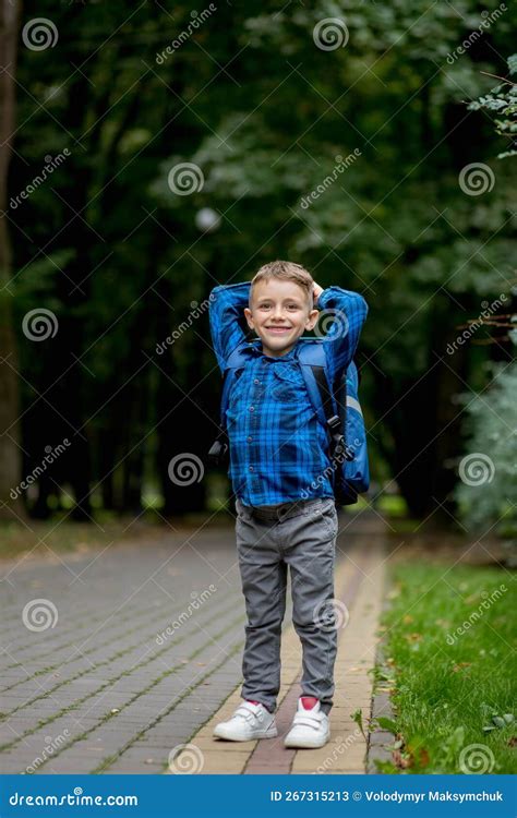 Portrait Of A First Grader With A Backpack The Boy Goes To School