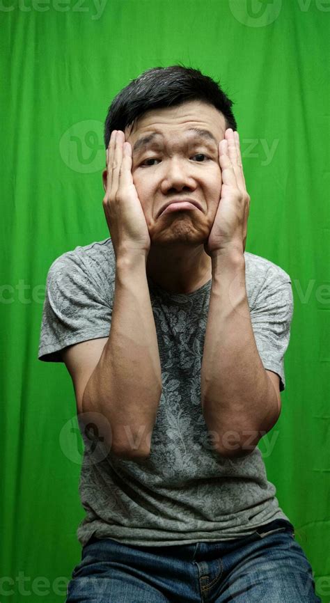 A Man Conveys Profound Emotion Through A Somber Expression Portrait Of