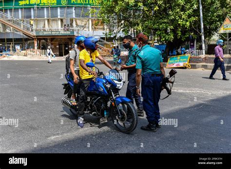 Bangladeshi Police Officers Stop A Motorist At A Checkpoint As