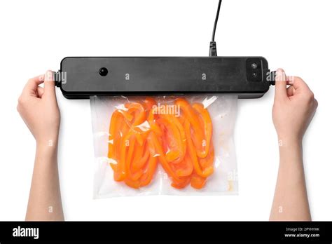 Woman Using Sealer For Vacuum Packing With Plastic Bag Of Bell Pepper