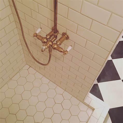 Polished Brass Bathroom Remodel With Subway Tile And Gray Grout