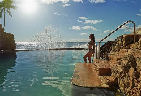 Pacific Islander Woman Relaxing In Pool By Colin Anderson Productions
