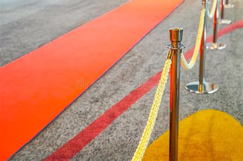 Rope Fencing With Gold Pillars With A Red Carpet For Celebrities And