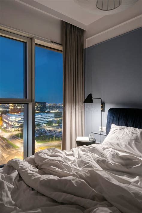 Light From A Wall Sconce Above A Bedside Table With A Book In Bedroom Stock Image Image Of