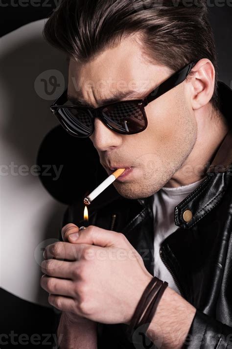 Lighting A Cigarette Handsome Male Model In Leather Jacket Lighting A