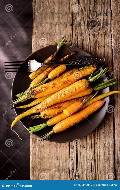 Baked Roasted Raw Freah Carrots With Olive Oil And Spices Lying On