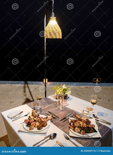 Luxury Dinner Table By The Ocean With Lobster Fish And Thai Food Stock