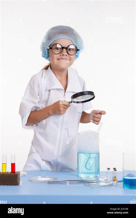 Chemist Girl Sitting At The Table With The Reagents In Chemistry Class And Puts Experiments