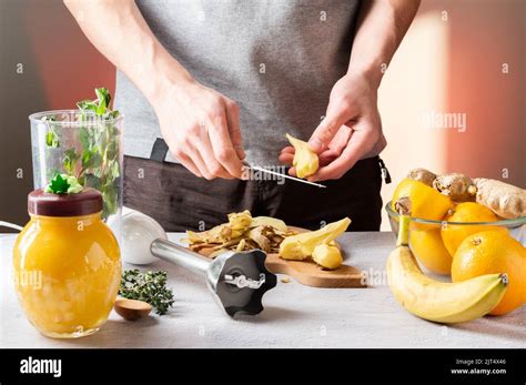 A Man Peels A Ginger Knife And Ginger Slices Prepare A Dish With