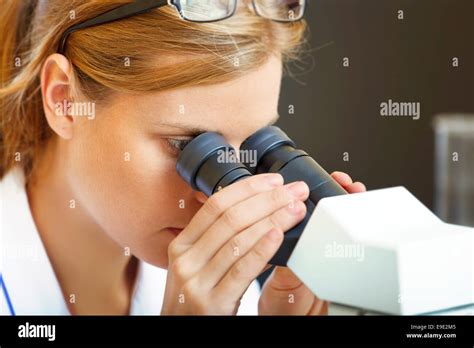 Beautiful Woman In A Laboratory Working With A Microscope Stock Photo Alamy