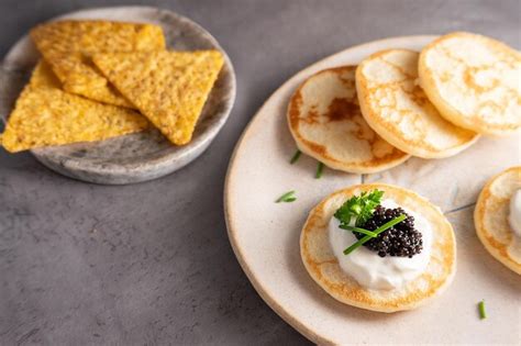 Premium Photo Pancakes Or Mini Blini With Black Caviar And Sour Cream