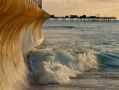 Premium Photo Sea Wave Splashing On Retaining Wall