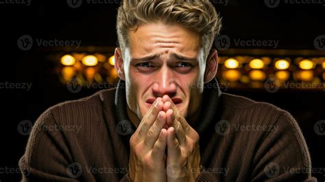 A Young Man Looking Distraught With Hands Clasped Together Generative