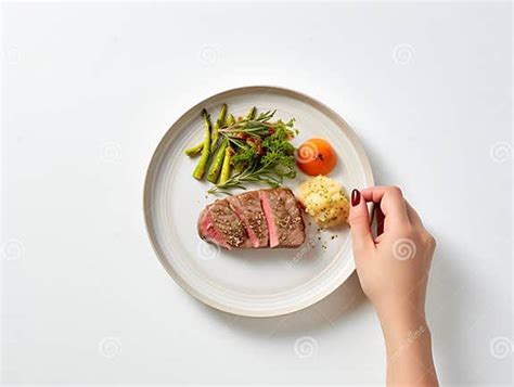 Elegant Fine Dining Steak Plating With Fresh Herbs And Minimalist
