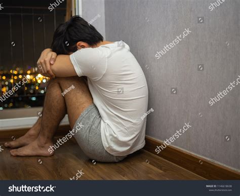 Person Sitting Down Holding Knees