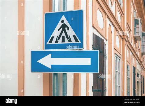 Pedestrian Crossing And Mandatory Direction Arrow Road Sign At The