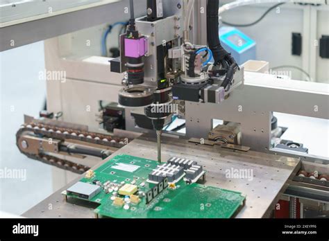 Automated Machine Assembling A Circuit Board Reflecting The Precision And Efficiency Of Modern