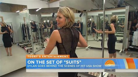 A Woman Standing In Front Of A Mirror Talking To Someone On The Set Of Suits