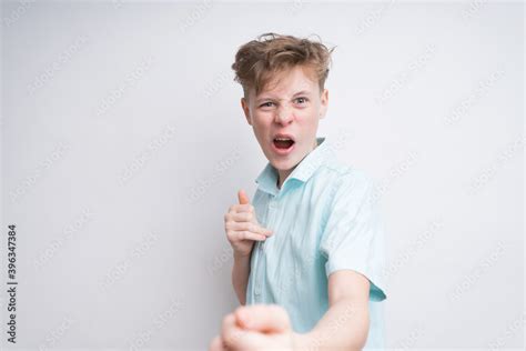 Funny Extraverted Caucasian Boy In A Blue Polo Shirt On A White