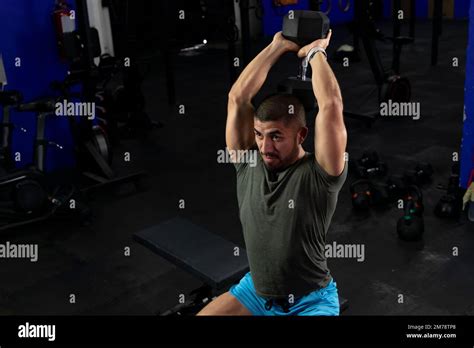 Muscular Latino Man Doing Exercises For Biceps Sitting On A Gym Bench Stock Photo Alamy
