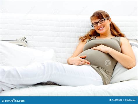 Pregnant Woman Lying on Sofa and Holding Her Belly Stock Photo - Image of gladness, gorgeous ...