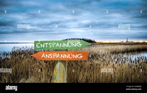 An Image With A Signpost Pointing In Two Different Directions In German