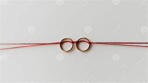 Elegant Wedding Rings On Red Thread Close Up Stock Illustration