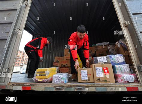 Chinese Couriers Of An Express Delivery Company Sort Out Parcels From