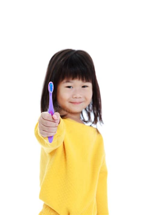 Sleepy Asian Girl With A Toothbrush In Hand Oral Health Concept Stock
