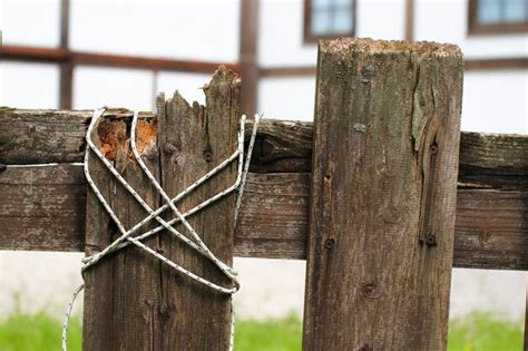 Premium Photo Detail Of Wooden Fence With White Rope Binding