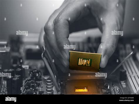 Electronic Engineer Hand Putting Computer Chip On Socket Chipset On Electronic Circuit Board Of