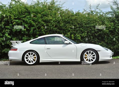 White Porsche 911 996 Gt3 In Side Profile Against Green Hedgerow