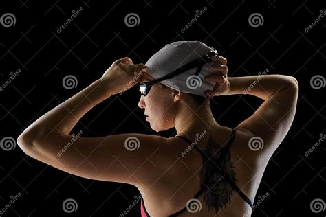 Rear View Portrait Of Young Woman Skilled Swimmer Adjusting Swim Cap