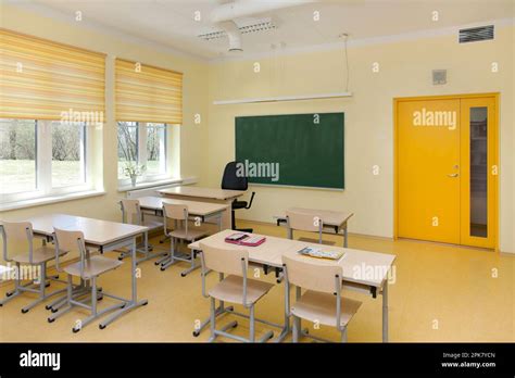 A Newly Built School Classroom With Desk And Chairs Windows With
