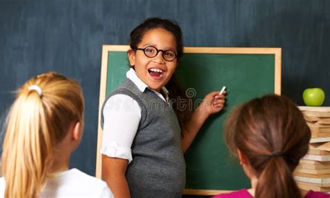 Shes Always Helping Her Classmates Portrait Of A Cute Girl Showing Her