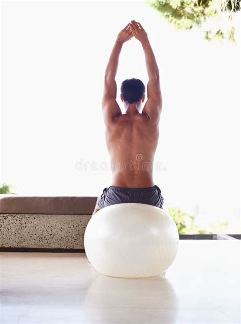 Releasing Tension A Rear View Shot Of A Muscular Young Man Stretching