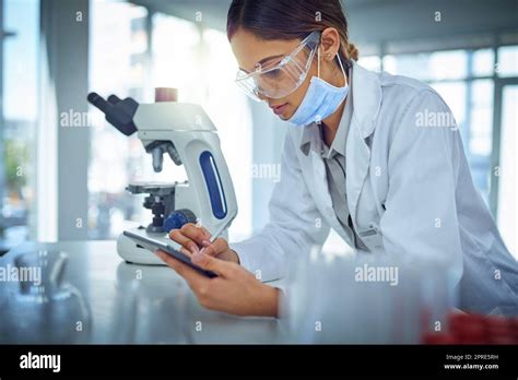 Collecting Data On Her Device A Female Scientist Using A Digital