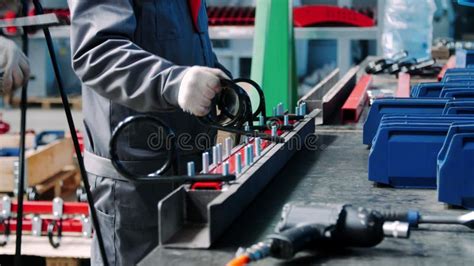 Workers Fixing Metal Parts Into Units In Workshop Of Manual Assemble