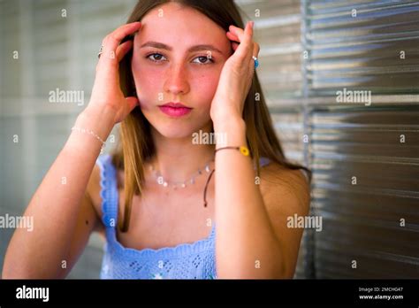 Close Up Portrait Of Teenage Girl Leaning Against Art Deco Glass Brick