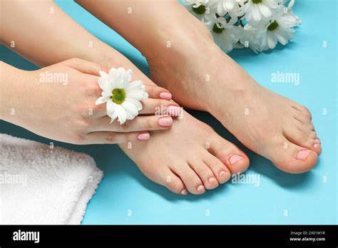 Woman With Neat Toenails After Pedicure Procedure On Light Blue