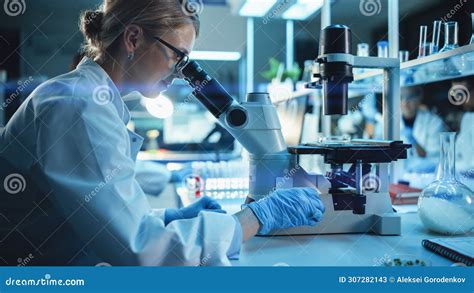 Medical Research Scientist Looks At Biological Samples Under Digital