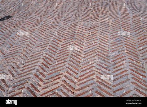 Red Brick Pavement Forming A Herringbone Pattern A Typical Element Of Historic European
